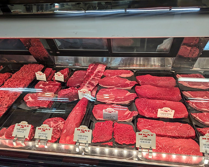 Carnivore's delight! These ruby-red cuts behind glass promise weekend grilling adventures and family dinner table stories.