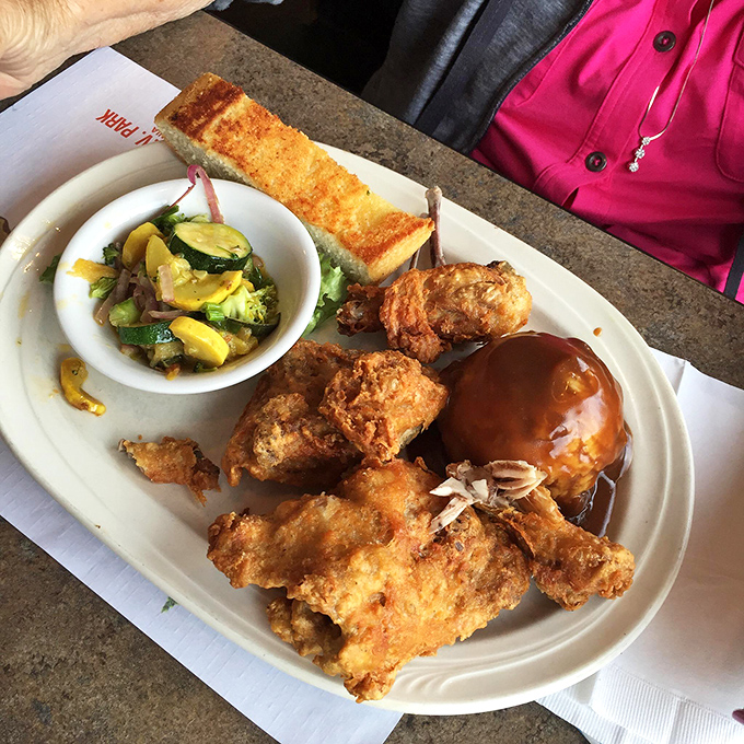 Fried chicken with skin so crispy it practically sings, paired with a baked potato and seasonal vegetables that aren't just plate fillers.