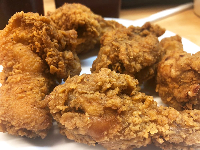 Fried chicken so perfectly golden it belongs in Fort Knox. The kind of crispy exterior that makes a satisfying sound when your fork breaks through.