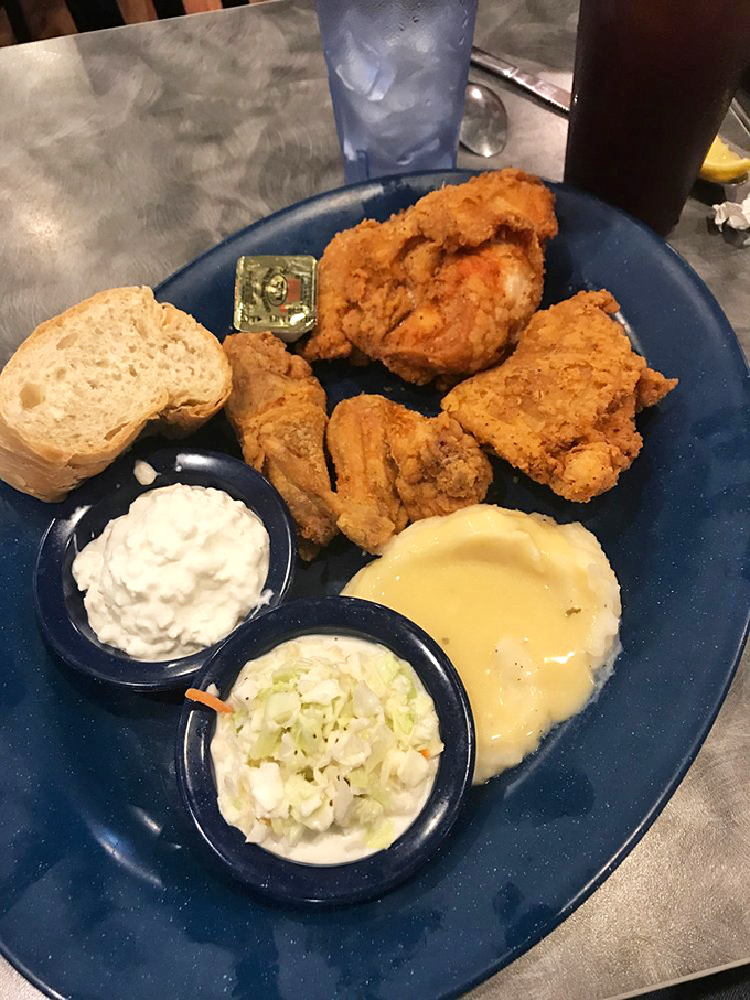 Fried chicken that looks like it belongs in a museum of comfort food perfection&mdash;golden, crispy exterior hiding juicy meat, with sides that know their supporting role.