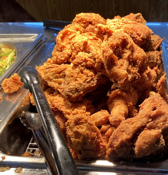 The fried chicken mountain&mdash;where crispy, golden-brown pieces wait patiently for you to make the difficult choice of thigh versus drumstick.