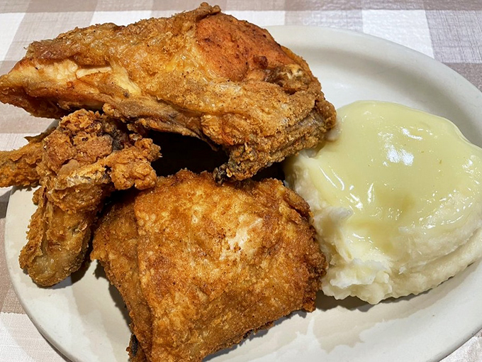 Fried chicken that achieves the impossible trifecta: shatteringly crisp exterior, juicy interior, and the power to make you forget all your table manners.