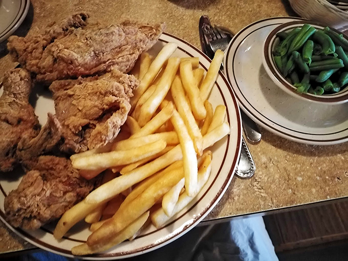 Fried chicken that would make your grandmother both proud and jealous. The golden crust whispers of secrets passed down through generations of skilled hands.