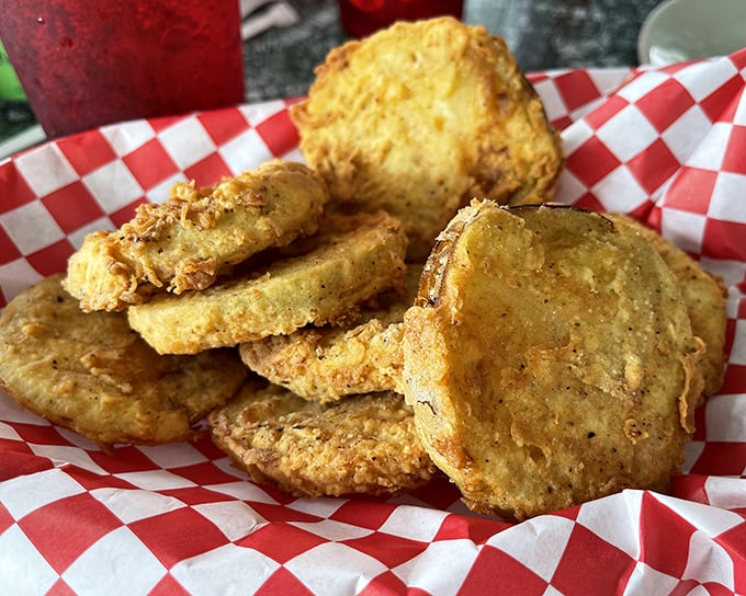 Fried green tomatoes stacked like golden poker chips, ready to cash in on Southern flavor. That red-checkered paper is the universal signal for "something delicious this way comes."