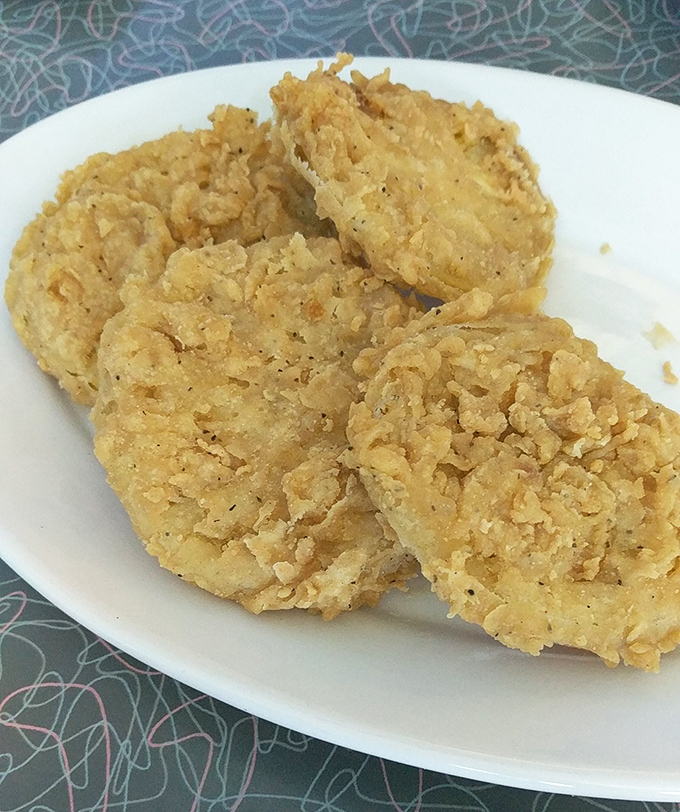 Fried green tomatoes that strike the perfect balance between tangy fruit and crispy coating, topped with a dollop of heaven.