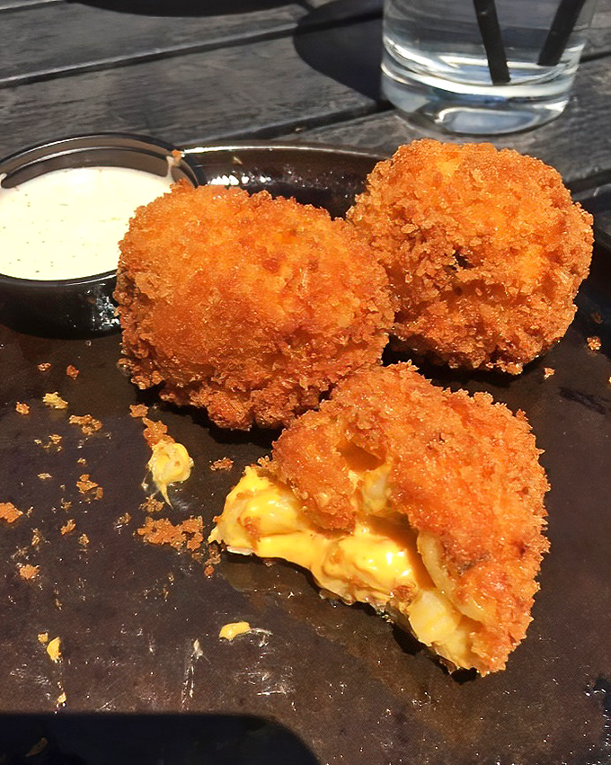 Mac and cheese balls that have achieved the perfect golden ratio – crispy exterior giving way to molten, cheesy interior. Worth every napkin you'll need.
