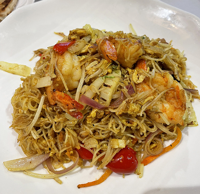 Singapore noodles that could make you temporarily forget your own name. A tangle of flavors that somehow makes perfect sense.