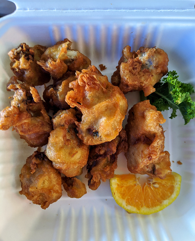Fried oysters that look like they're auditioning for the seafood hall of fame, complete with a lemon wedge for that perfect zing.