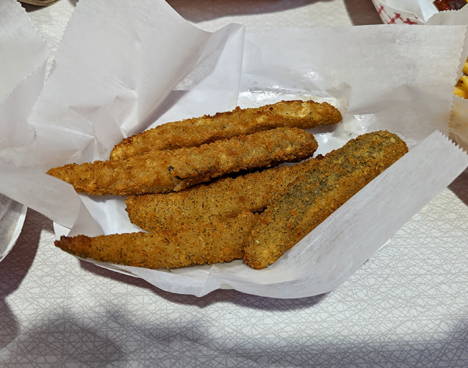 Golden-fried pickle spears &ndash; the unexpected sidekick that steals scenes with its perfect balance of crispy exterior and tangy interior.