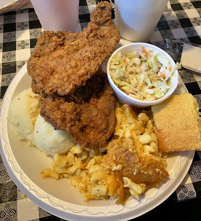 A plate that means business: fried chicken, mashed potatoes, mac and cheese, coleslaw, and cornbread &ndash; the kind of meal that demands a post-dinner nap.