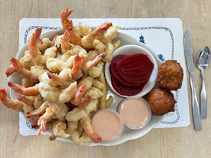 A mountain of fried shrimp that makes you wonder if you've died and gone to seafood heaven, complete with hush puppies as your celestial companions.