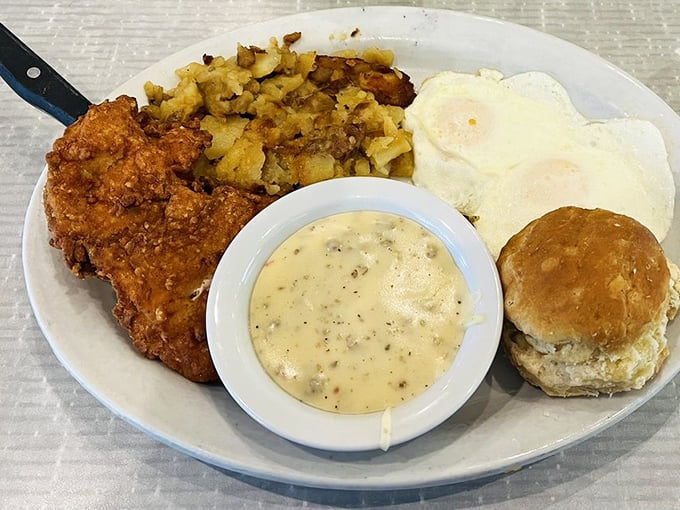 Country fried steak with eggs, hash browns, and a biscuit&mdash;the breakfast equivalent of winning the lottery. That gravy cup is liquid gold!