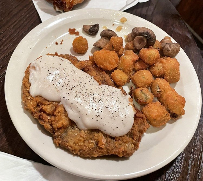 Country-fried steak smothered in gravy with a side of fried okra&mdash;a plate that says "you're definitely in the Ozarks now, friend."