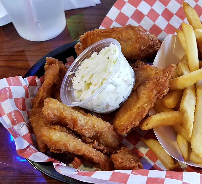 A basket of crispy delights paired with fresh-cut fries and homemade coleslaw&mdash;the holy trinity of fish house perfection that keeps locals coming back weekly.