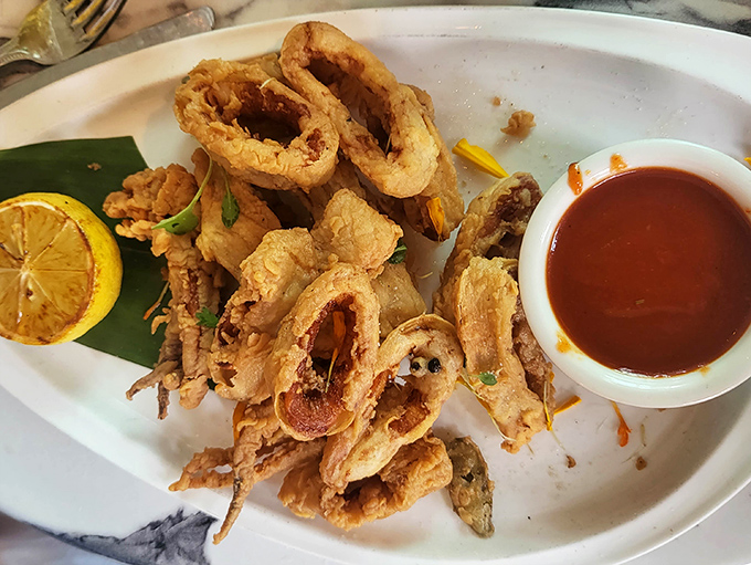 Golden calamari rings that crunch like autumn leaves, served with a sauce that demands extra napkins.