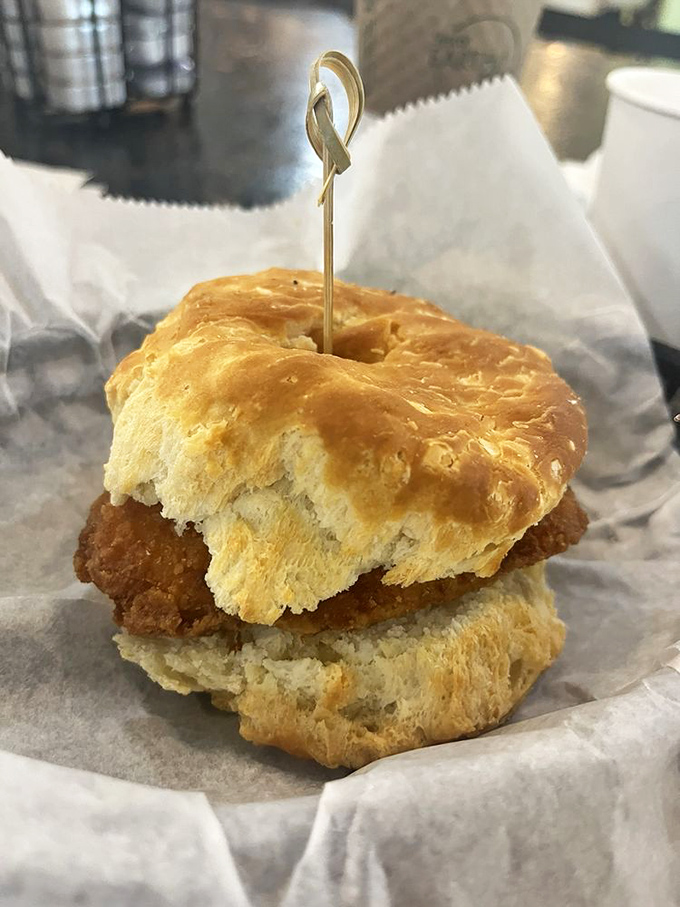 This biscuit sandwich isn't messing around. Golden, flaky architecture supporting a perfectly fried chicken centerpiece&mdash;breakfast engineering at its finest.