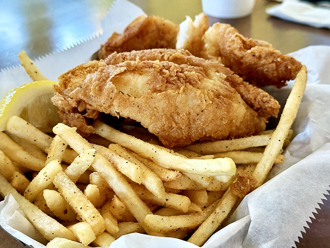 Golden-fried fish resting on a bed of fries&mdash;proof that sometimes the simplest combinations create the most profound happiness.