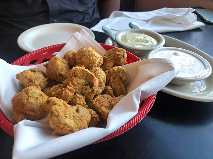 These aren't just fried mushrooms – they're little golden orbs of happiness, crispy on the outside, juicy within, begging to be dunked.