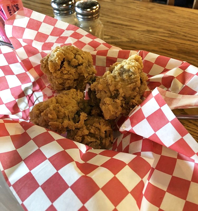 Fried mushrooms nestled in their red-checkered paper throne&mdash;golden, crispy armor protecting tender treasures within. Worth every napkin.