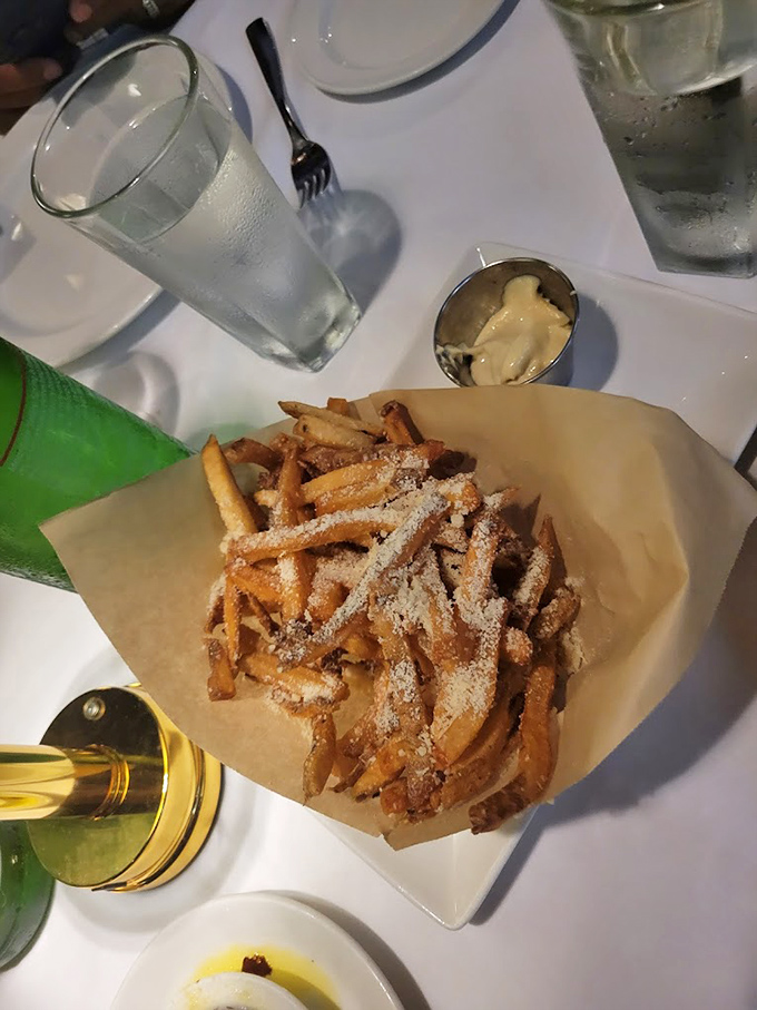 Parmesan truffle fries: where potato meets luxury in a paper-lined basket. The kind of side dish that steals focus from the entr&eacute;e.