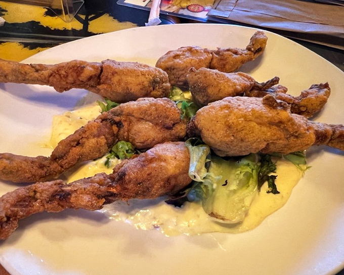 Frog legs: the dish that makes you say "I can't believe I waited this long to try these." Crispy, tender, and served with a sauce worth bottling and taking home.