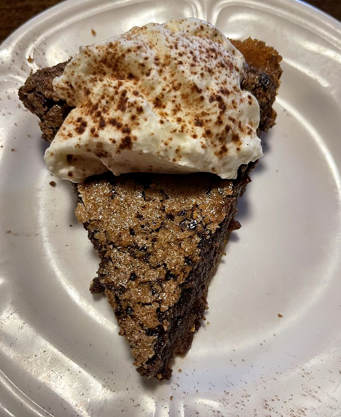 A slice of fudge pie topped with cream that doesn't just satisfy your sweet tooth &ndash; it throws a party for it and invites all its friends.