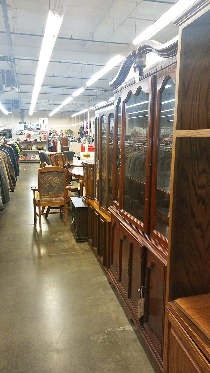 A magnificent wooden china cabinet stands sentinel among other furniture finds&mdash;craftsmanship that would cost ten times more elsewhere.