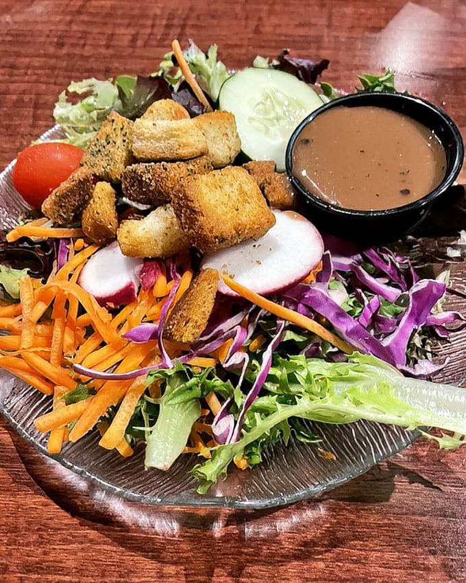 A garden party on a plate! This salad's colorful crunch and housemade dressing prove that vegetables can absolutely steal the show.