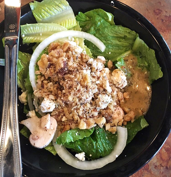 Fresh greens, crumbled cheese, and crunchy toppings make this salad more than just pizza's opening act—it's a star in its own right.