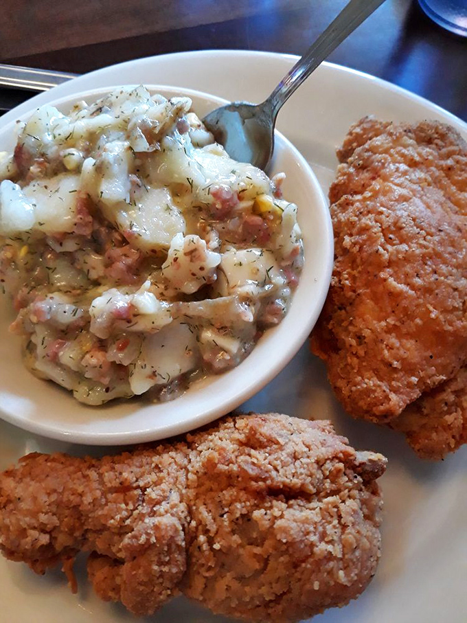 German potato salad with bits of bacon hiding among the potatoes like delicious little treasures in a starchy sea.