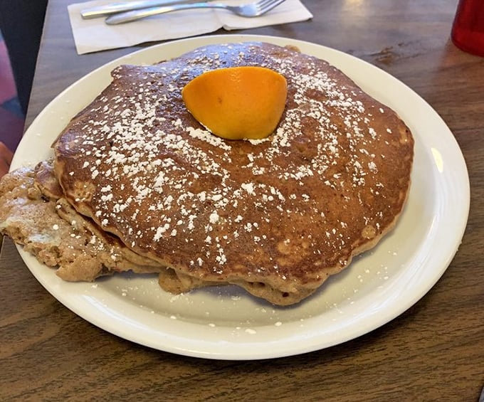 The griddle cake that launched a thousand food pilgrimages&mdash;wider than the plate, dusted with powdered sugar, and crowned with a pat of butter.
