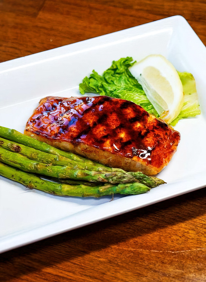 This glazed salmon with asparagus isn't just dinner&mdash;it's edible artwork. The caramelized exterior glistens with a promise it absolutely keeps.