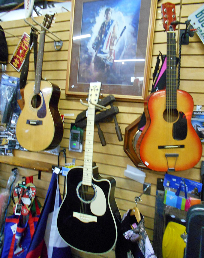 A wall of guitars silently promises musical adventures, each instrument carrying melodies of its previous life.
