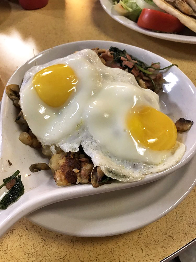 Two eggs perched atop a savory medley of mushrooms and potatoes &ndash; proof that sometimes the best views at an airport aren't through the windows.