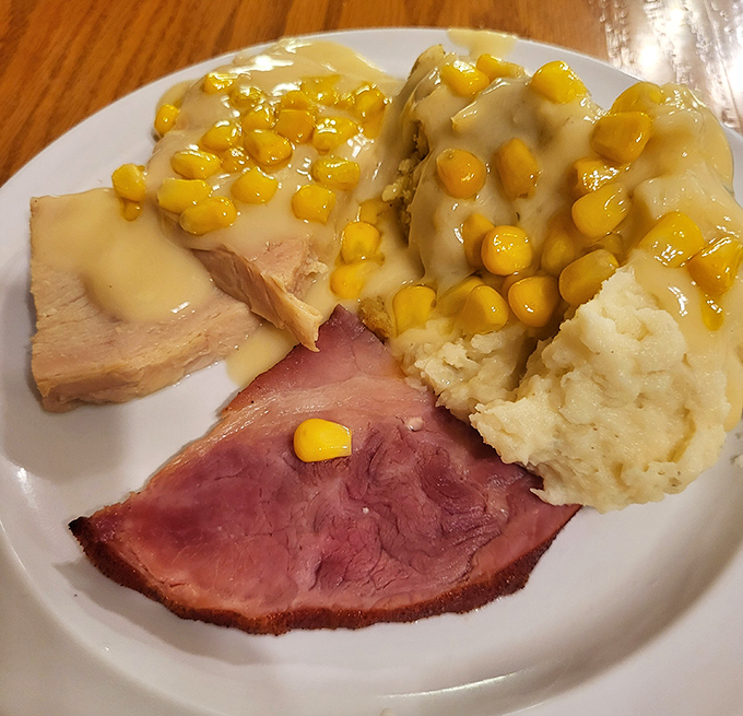 Ham loaf with mashed potatoes and corn&mdash;a plate that screams "Midwest comfort" louder than a high school basketball coach during championship season.