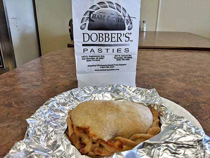 The humble paper bag holds the promise of future feasts, with Dobber's logo guaranteeing satisfaction with every pasty.