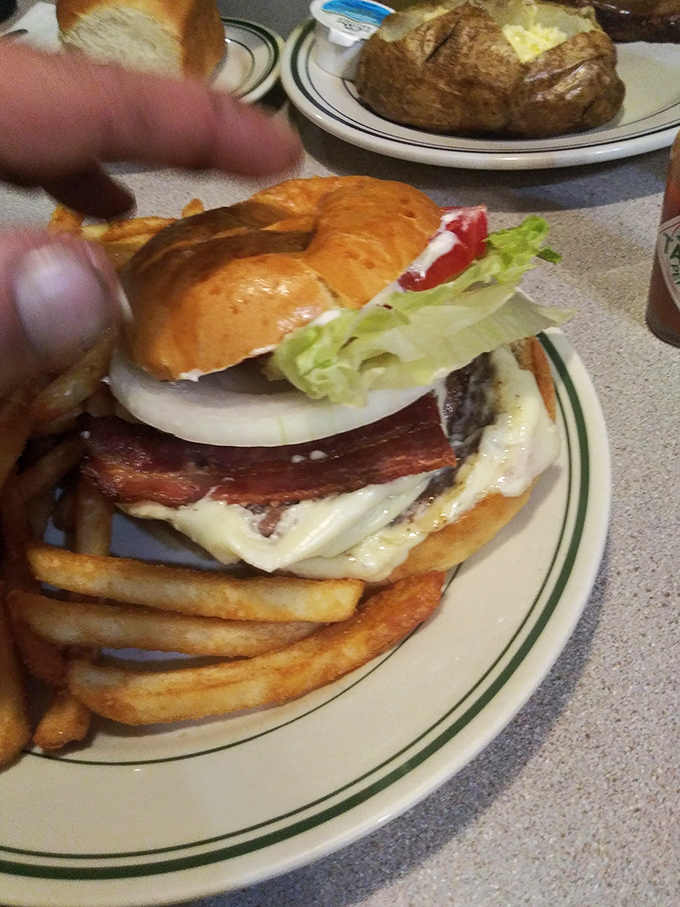 This isn't just a burger&mdash;it's architecture. The bacon's hanging off the edge like it's showing off, and rightfully so.