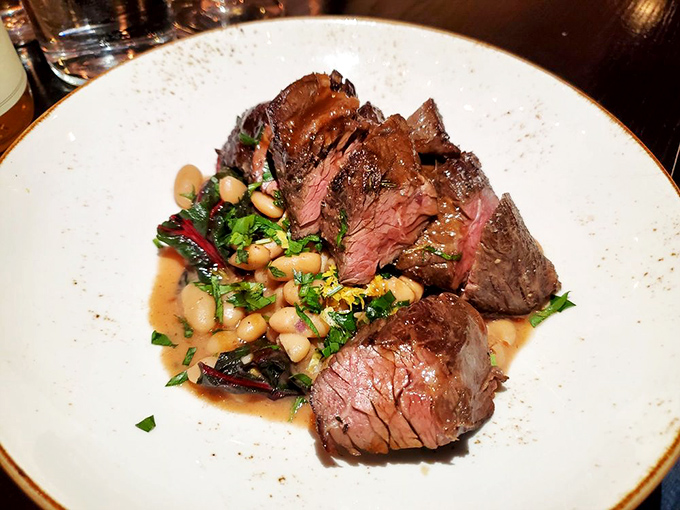 Perfectly medium-rare steak with beans and greens. The kind of plate that makes you wonder why you ever bother cooking at home.