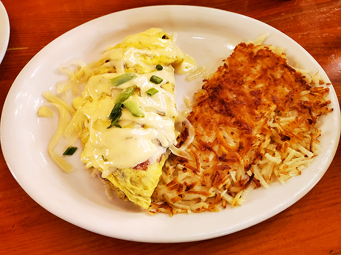 Hash browns achieving that golden-crispy nirvana, topped with eggs ready to create yolk magic on your plate.