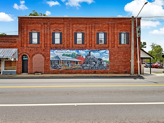 Art meets history on this vibrant mural where locomotives and memories of Havana's railroad glory days come alive on weathered brick.