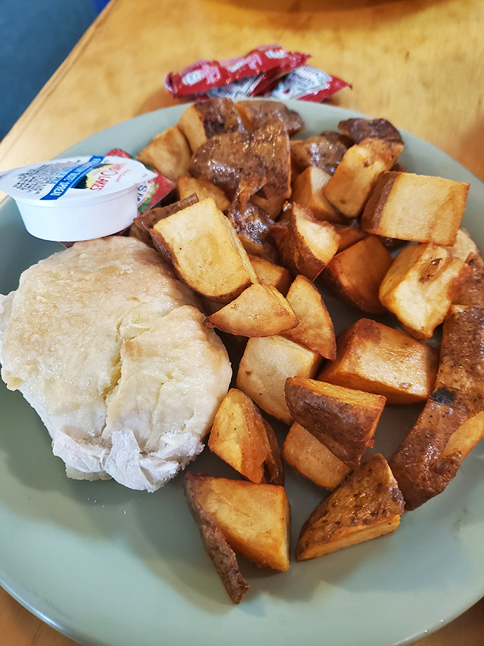 Home fries crisped to perfection alongside a fluffy biscuit. Breakfast of champions, or at least very happy humans.