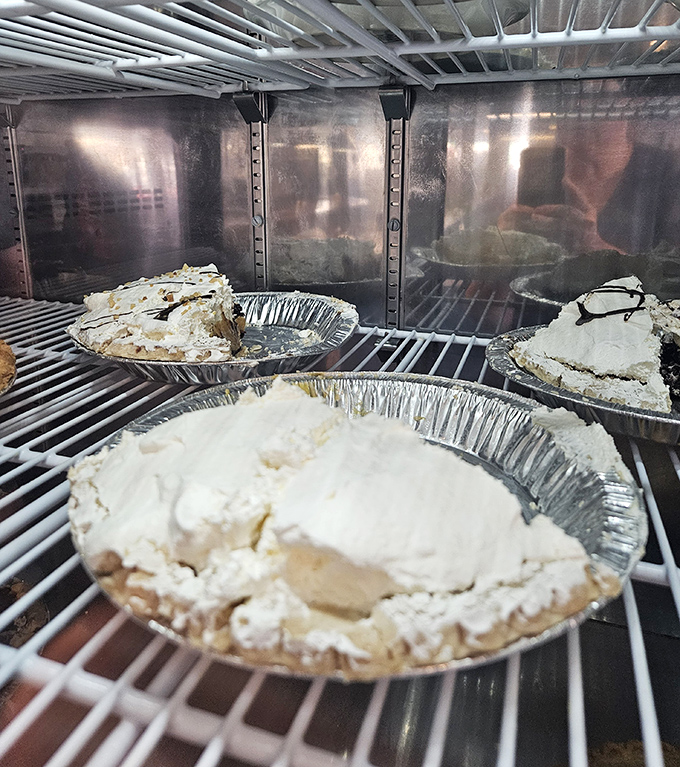 Pie heaven awaits in that display case. Each tin holds the kind of dessert that makes you seriously consider ordering it before your main course.
