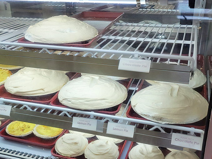 The cream pies stand at attention like soldiers in a delicious army, their meringue peaks reaching toward heaven with good reason.
