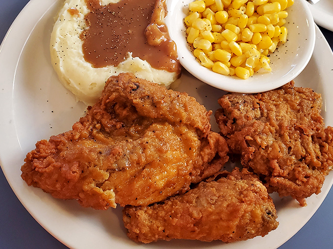 Fried chicken so perfectly golden it belongs in Fort Knox, paired with sides that don't know they're supposed to be supporting actors.
