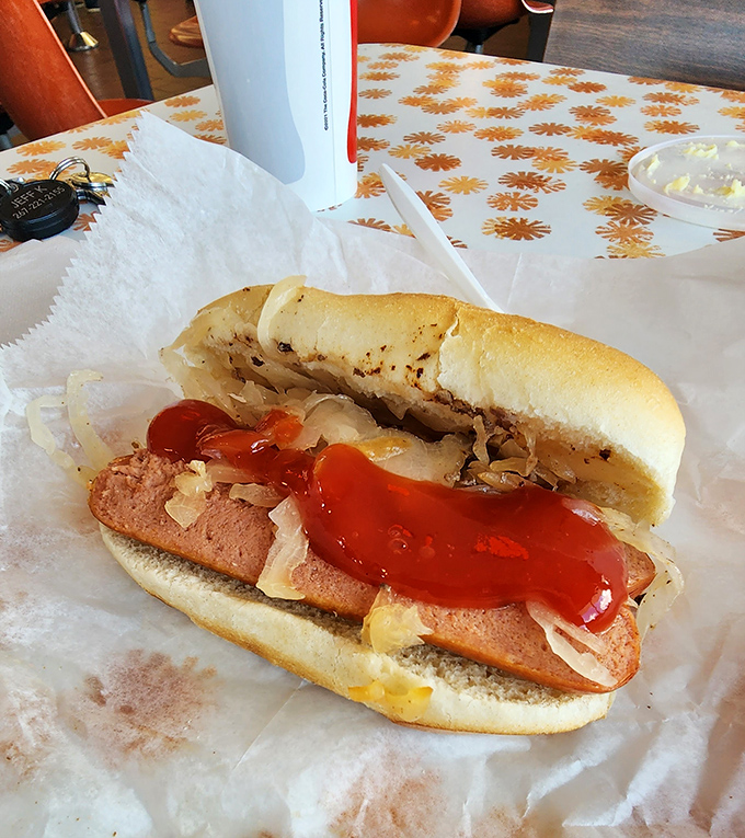 The hot dog comes dressed for success with sauerkraut and ketchup&mdash;proof that simple pleasures are often the most satisfying.