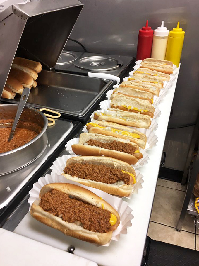Assembly line of happiness&mdash;these chili dogs lined up like soldiers ready to battle hunger with mustard-yellow streaks of deliciousness.