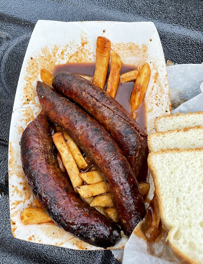 Hot links lounging in sauce like they own the place, with french fries playing the willing accomplices to this delicious crime.