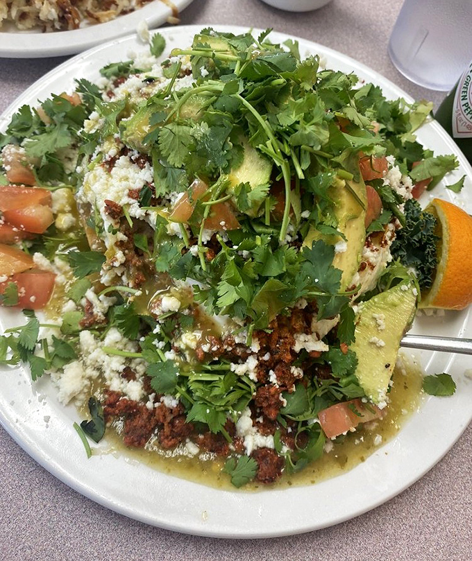 This isn't just Huevos Rancheros&mdash;it's a fiesta on a plate where cilantro confetti rains down on avocado mountains and chorizo valleys.