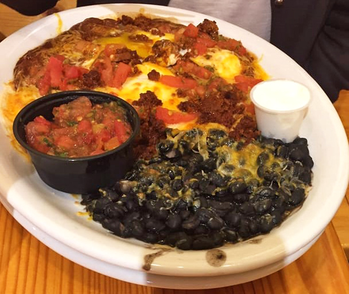Southwest meets sunrise in this colorful plate of huevos rancheros, where black beans and melted cheese come together in a breakfast symphony.