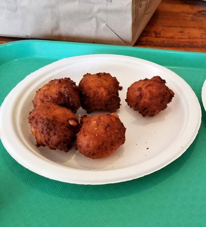 Hush puppies with personalities as round as their shape. These golden orbs of cornmeal joy are the unsung heroes of any seafood feast.